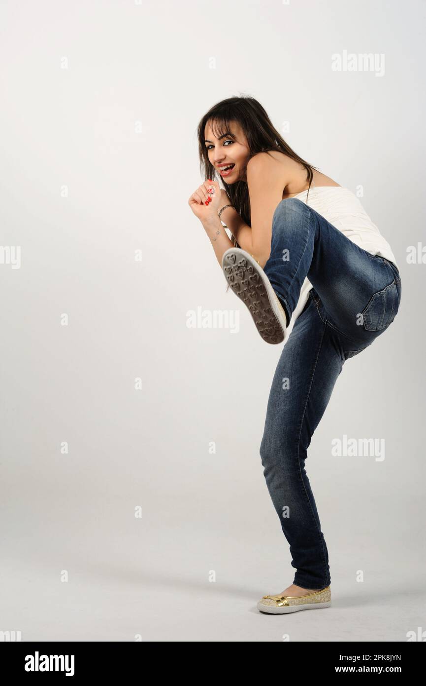 Young woman dancing breakdance in the studio on white background. in a ...