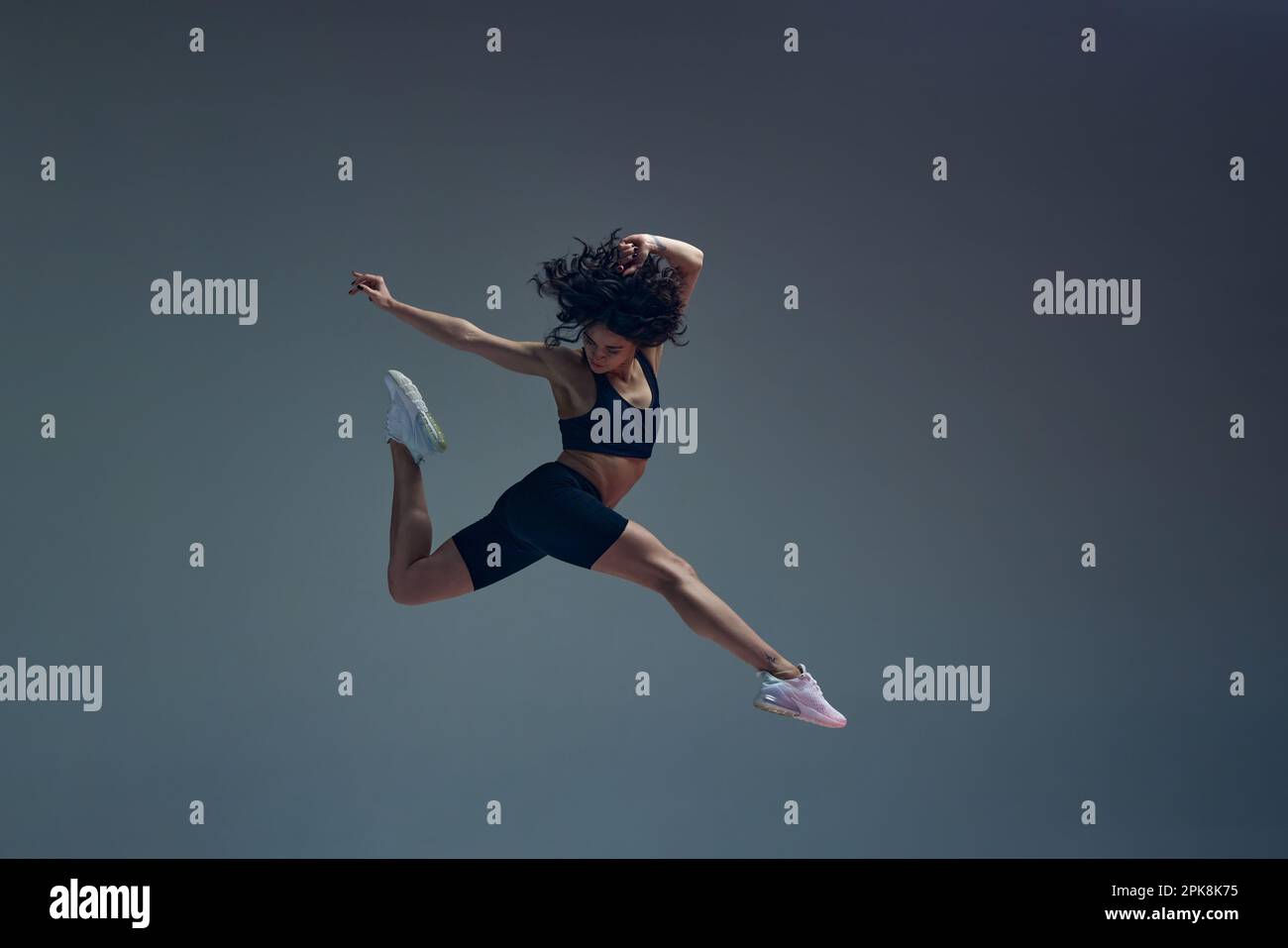 In motion. Art of movement. Attractive young woman with slim, fit body ...