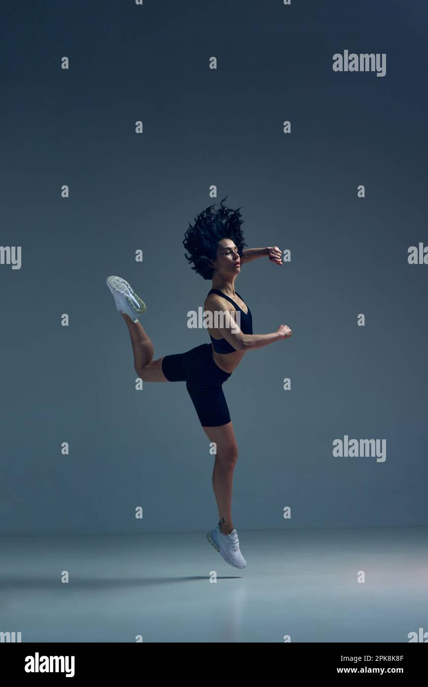 In motion. Art of movement. Attractive young woman with slim, fit body ...