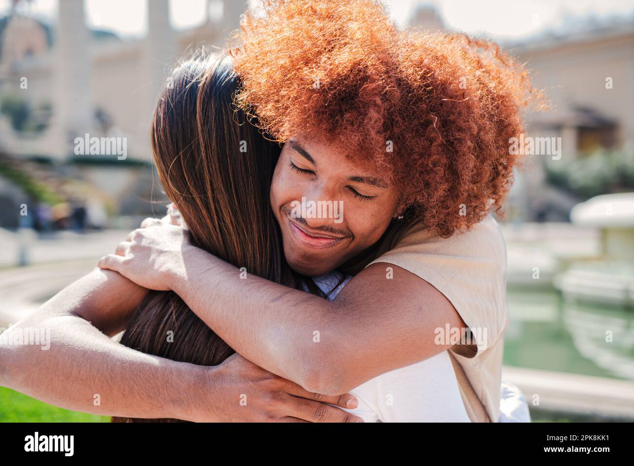 close up portrait of teenage joyful couple embracing together. One ...