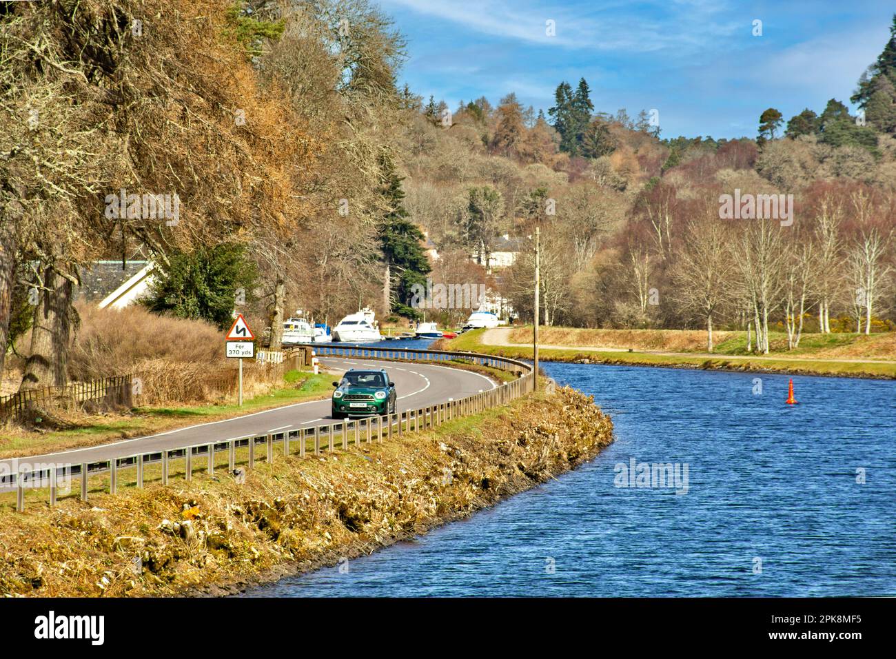 Car on the busy A82 road as it passes the Caledonian Canal at ...