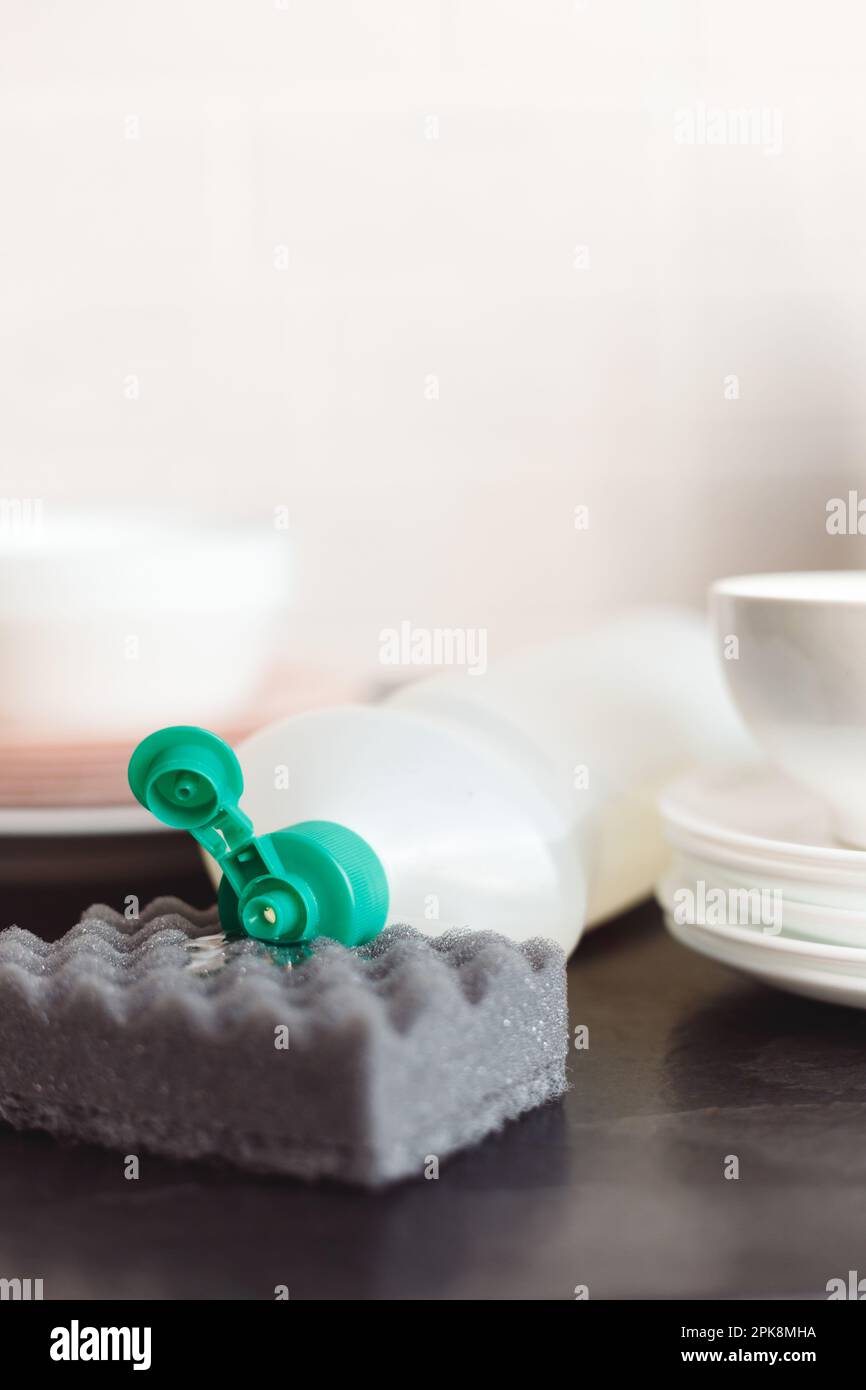 Close-up of Dishwashing Liquid flows from Bottle on to Sponge on ...