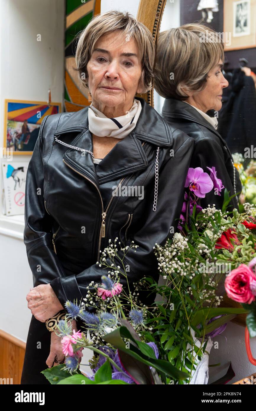 90 years old, well aged woman, former singer, with flowers after her ...