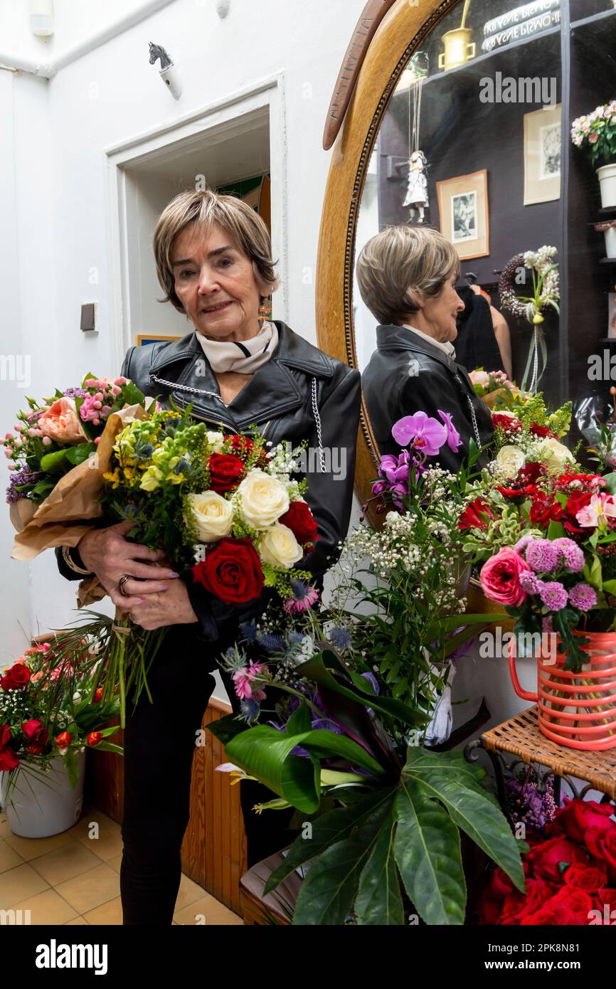 90 years old, well aged woman, former singer, with flowers after her ...
