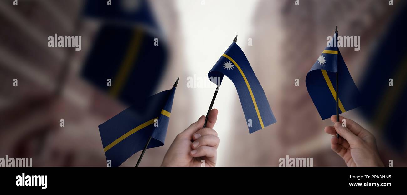 A group of people holding small flags of the Nauru in their hands Stock ...