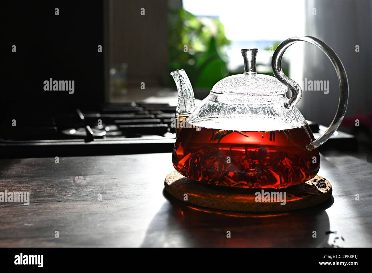 A woman's hand pouring tea into a mug. Steamed tea, morning tea, home ...