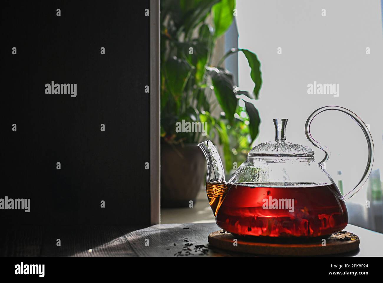 A woman's hand pouring tea into a mug. Steamed tea, morning tea, home ...