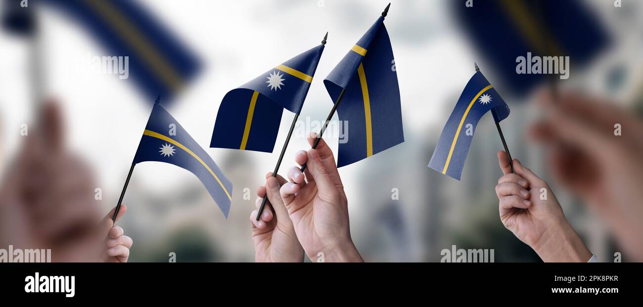 A group of people holding small flags of the Nauru in their hands Stock ...