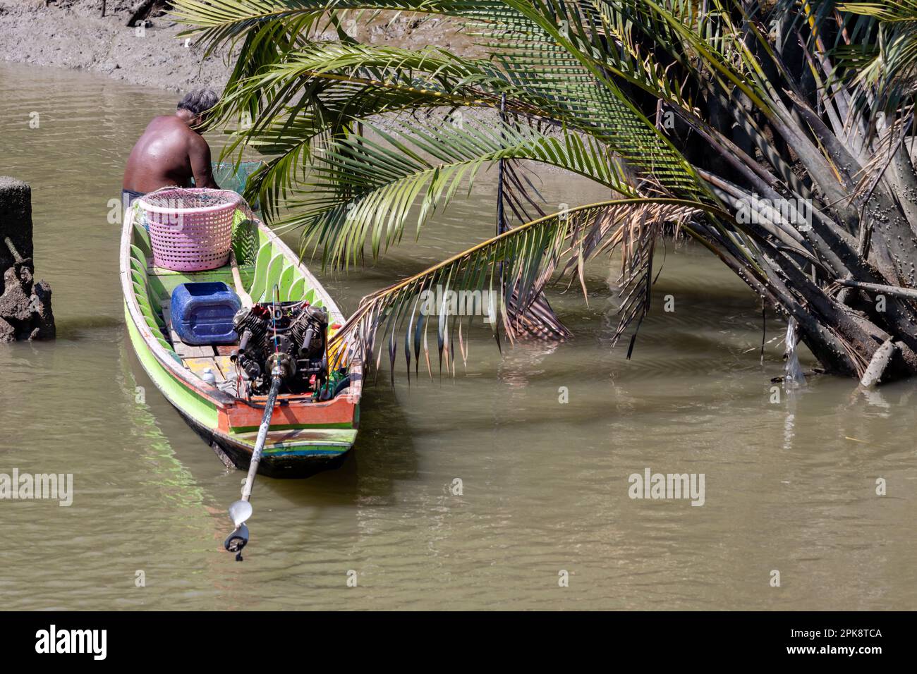 A fisherman on a boat checks the net traps he pulls out of the water at ...