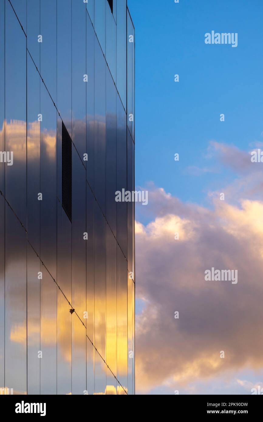 Clouds at sunset reflected in the facade of a modern building Stock ...