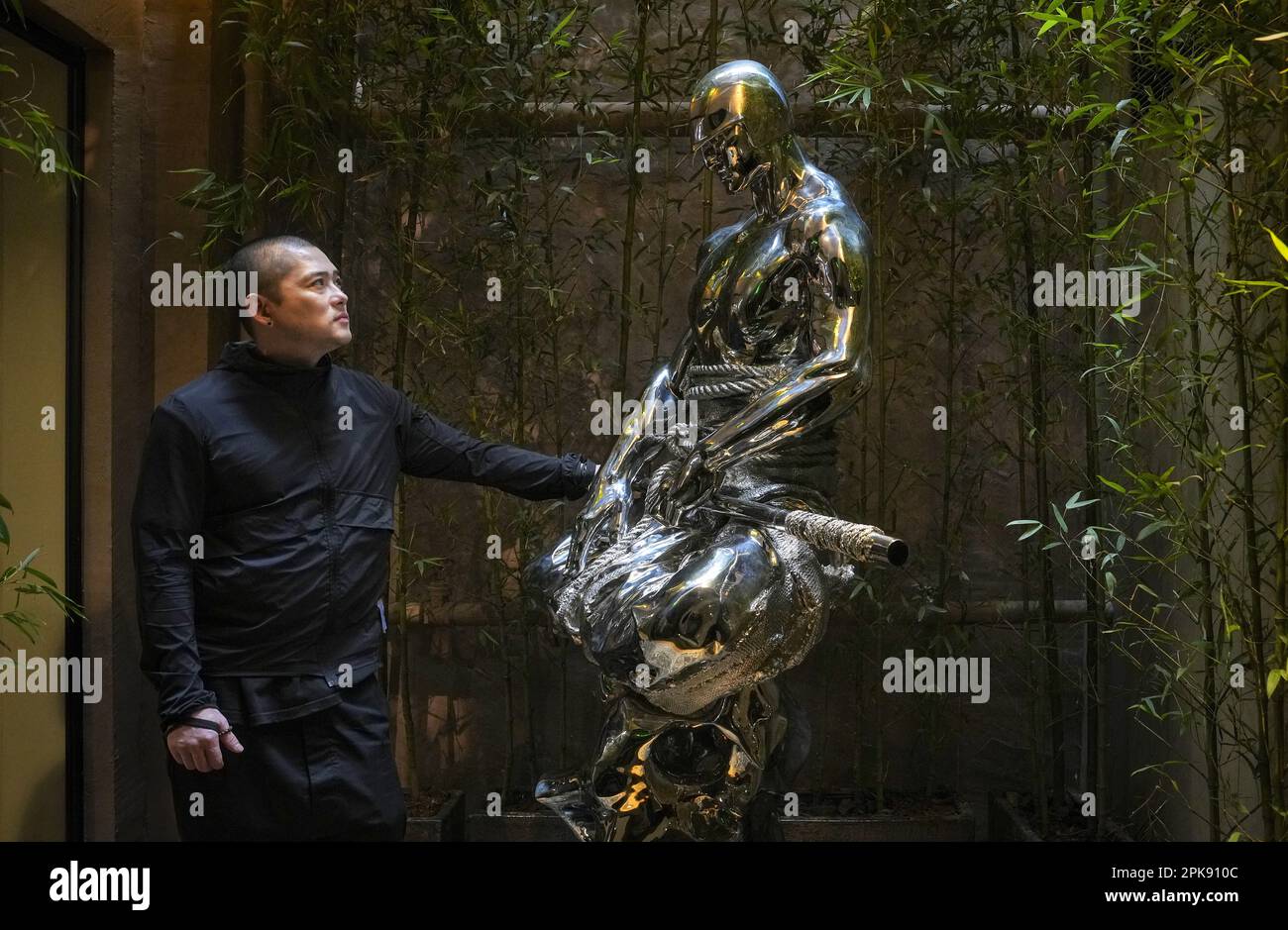 Sculptor Ren Zhe, poses for pictures inside his gallery in Central ...