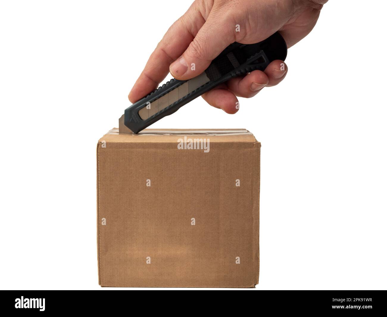 The cardboard box is opened with a knife. White background Stock Photo ...