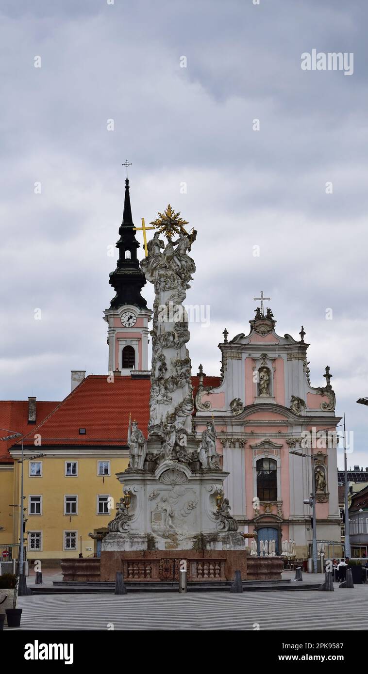 Franciscan church and Holy Trinity statue in St Polten, Austria ...