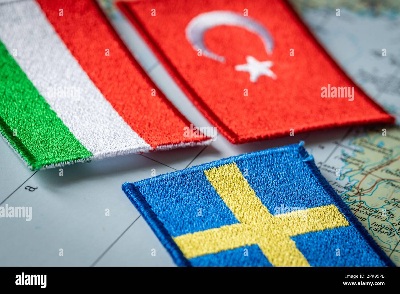 The flags of Turkey and Hungary in front of the symbol of Sweden. The ...