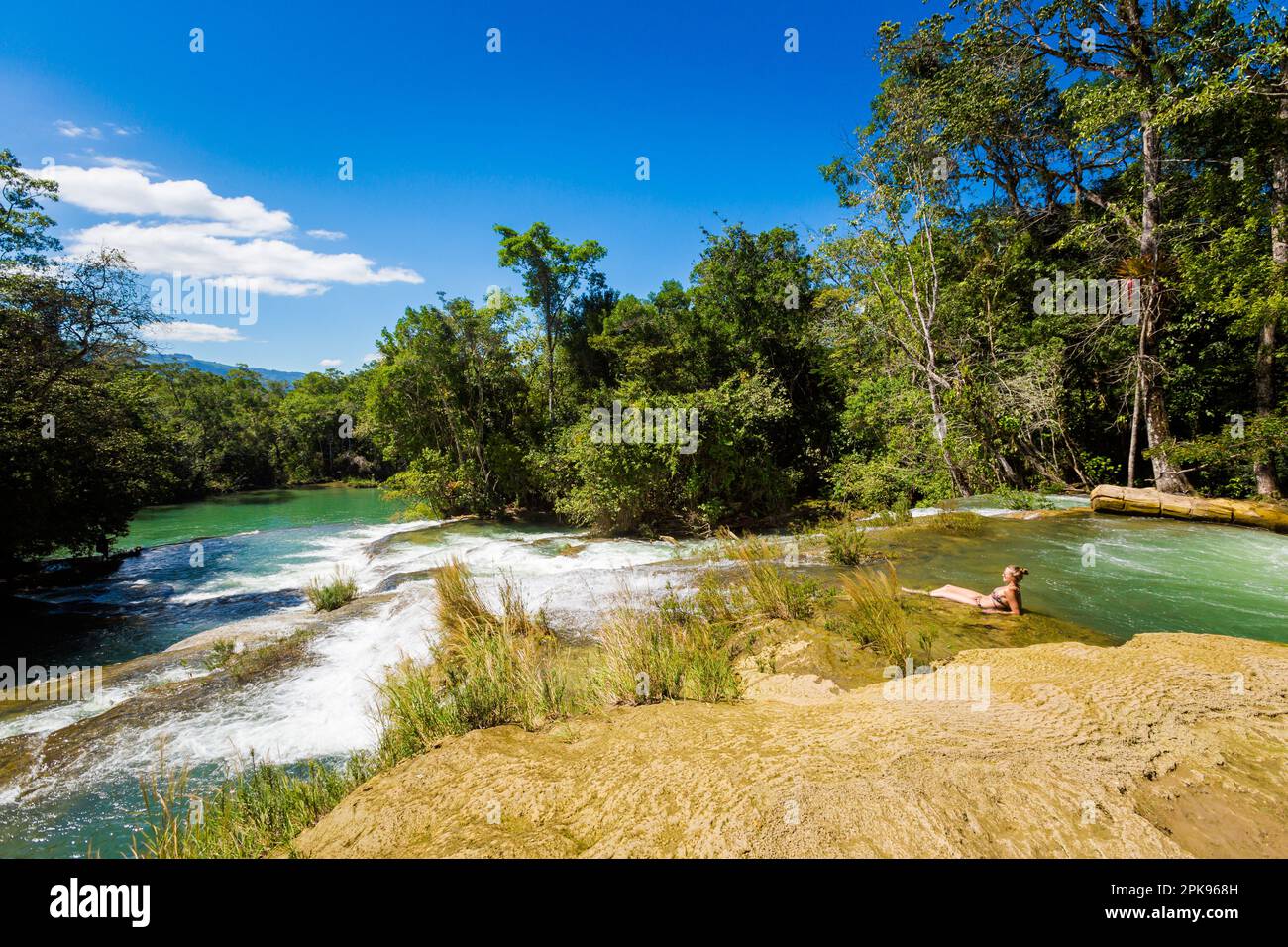 Young pretty woman relaxing by the water in Roberto Barrios cascadas ...
