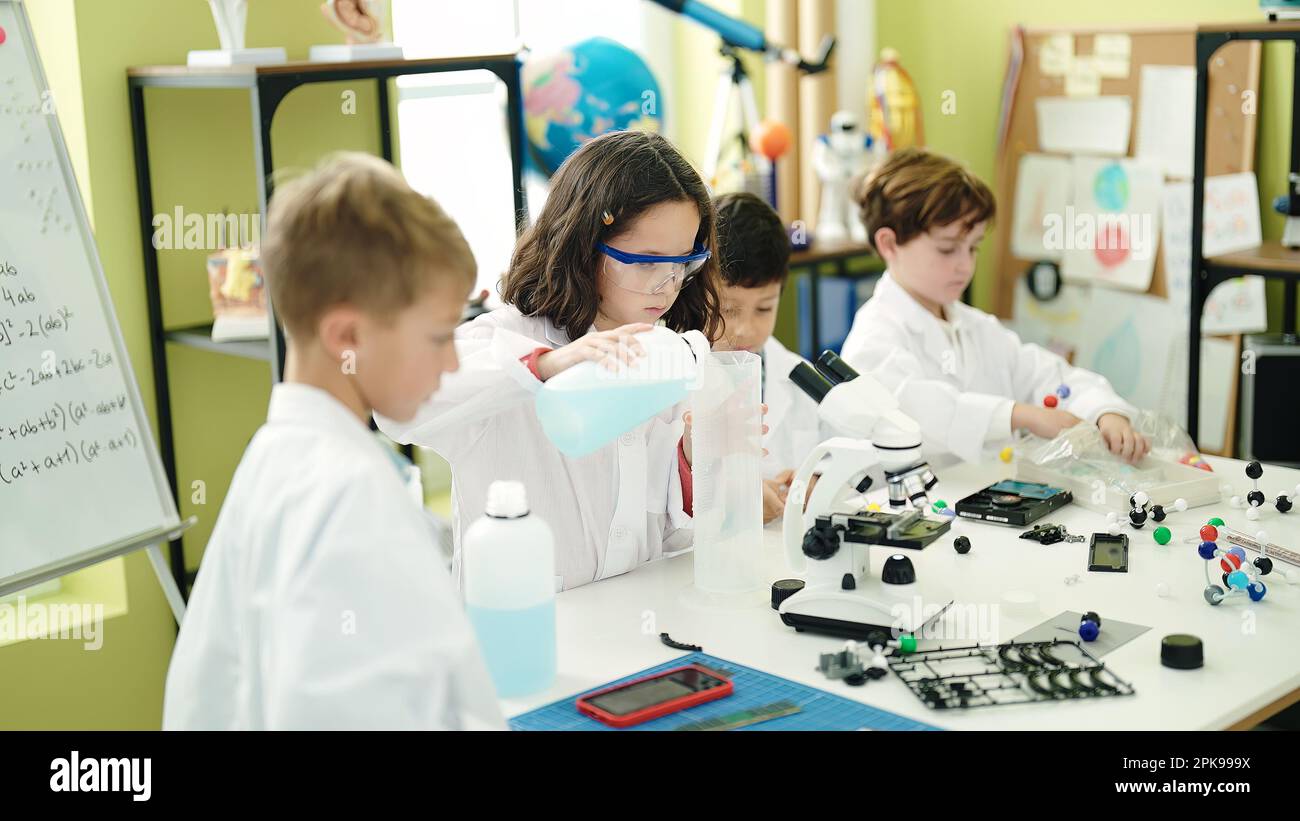 Group of kids students pouring liquid on bottl doing experiment at ...