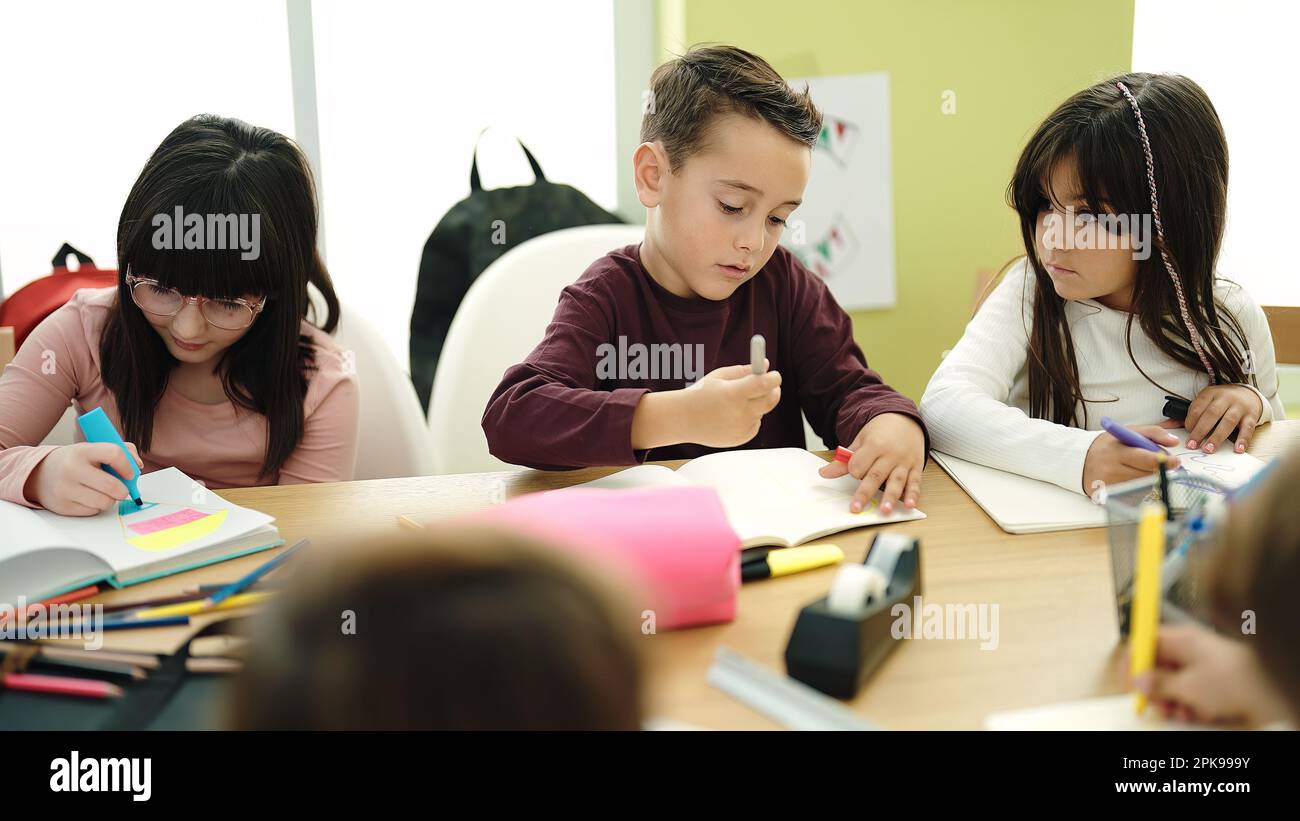Group of kids students sitting on table studying at classroom Stock ...