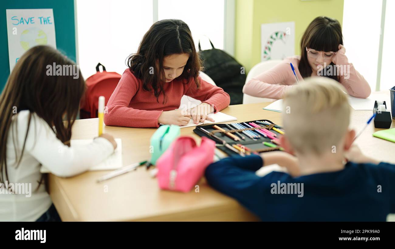 Group of kids students sitting on table studying at classroom Stock ...
