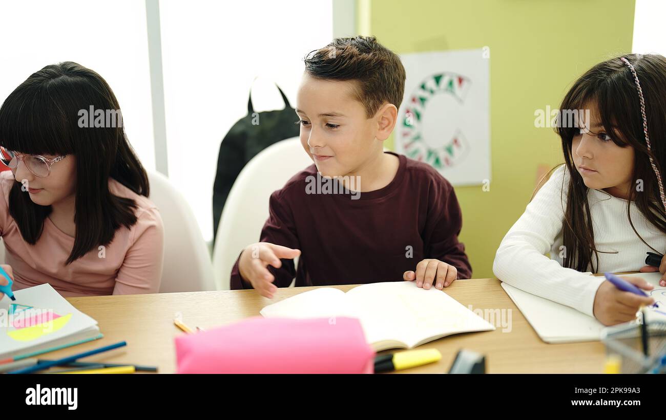 Group of kids students sitting on table studying at classroom Stock ...