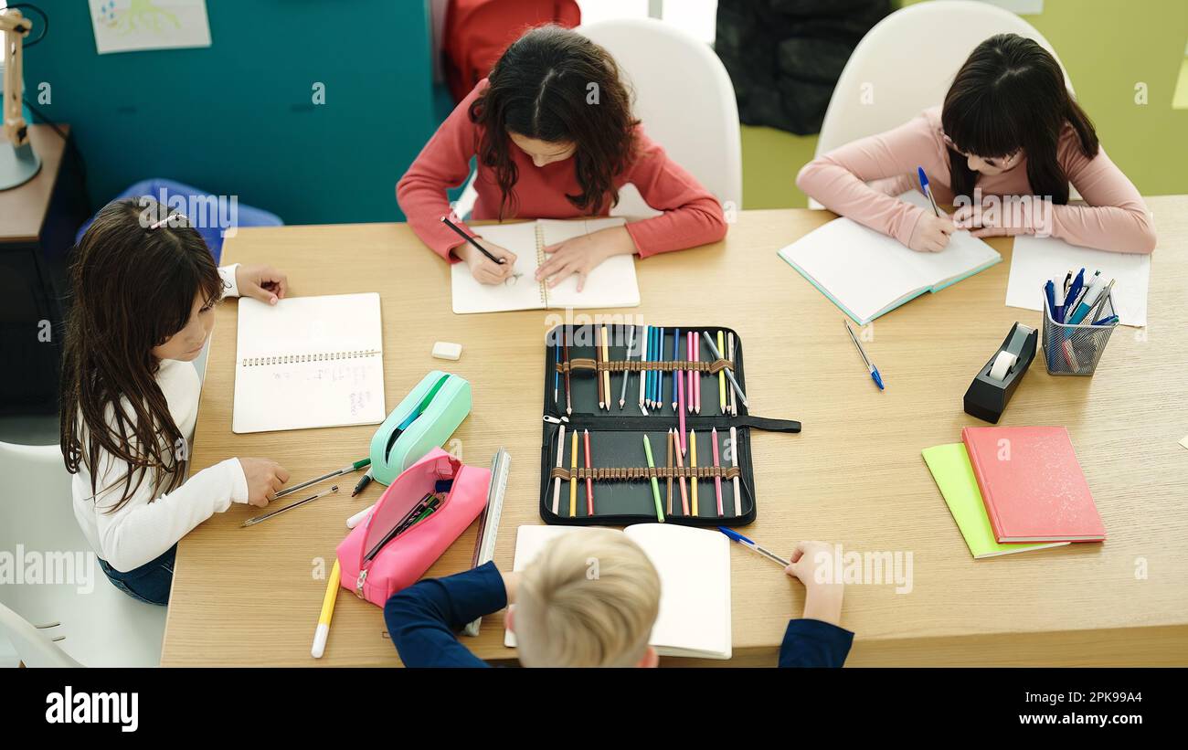 Group of kids students sitting on table studying at classroom Stock ...