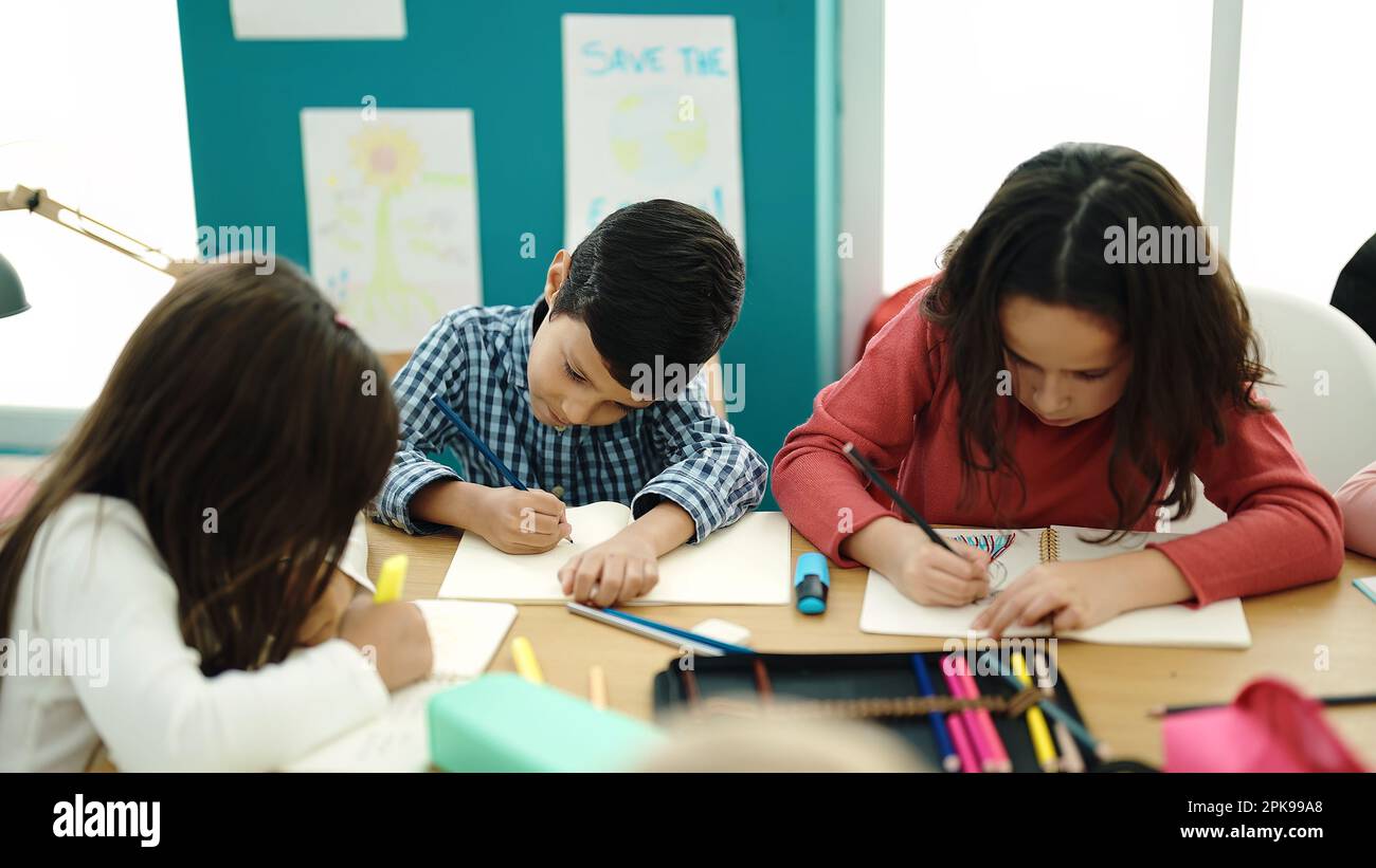 Group of kids students sitting on table studying at classroom Stock ...