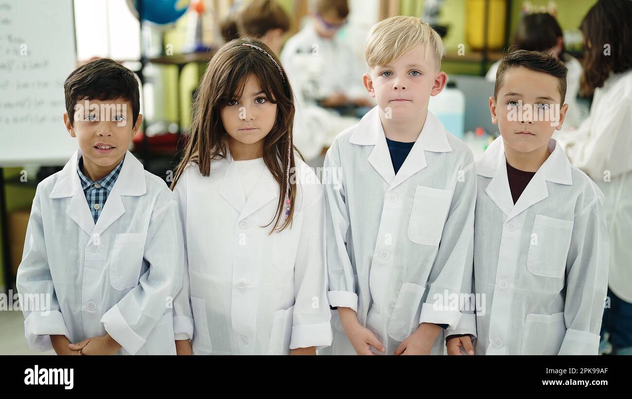 Group of kids scientists students standing with relaxed expression at ...