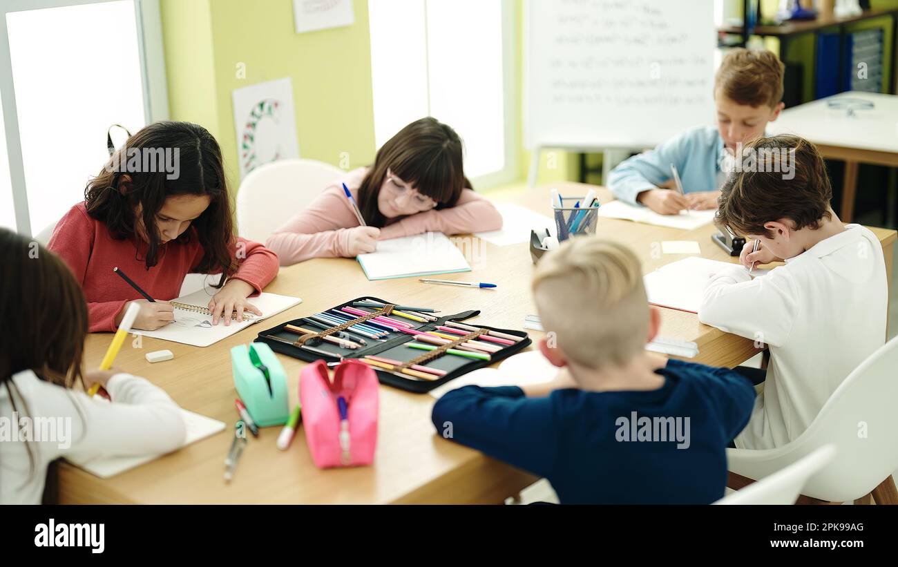 Group of kids students sitting on table studying at classroom Stock ...