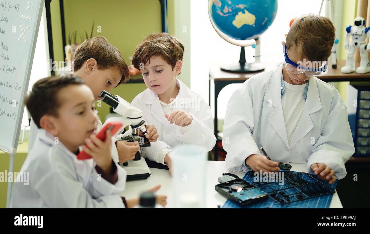 Group of kids students talking on smartphone repairing gadget at ...