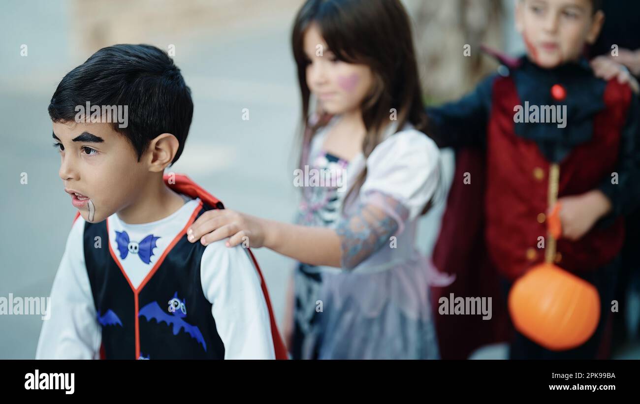 Group of kids wearing halloween costume walking together at street ...