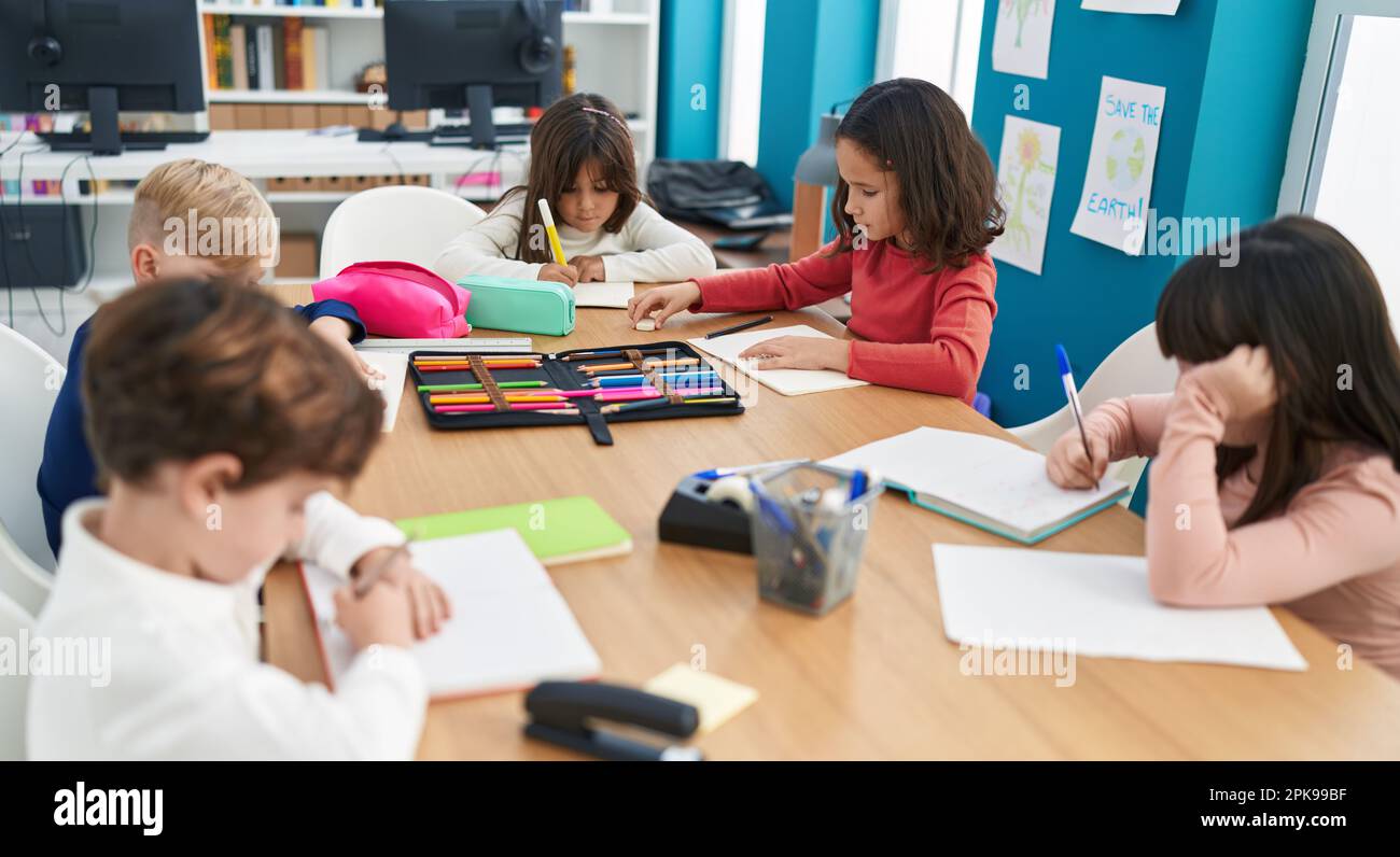 Group of kids students sitting on table studying at classroom Stock ...