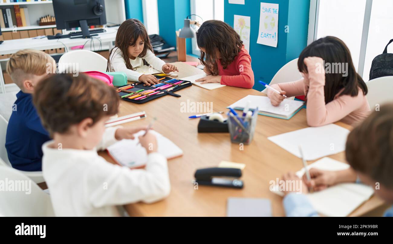 Group of kids students sitting on table studying at classroom Stock ...