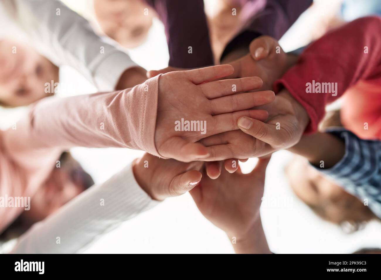 Group of kids students with hands together at classroom Stock Photo - Alamy
