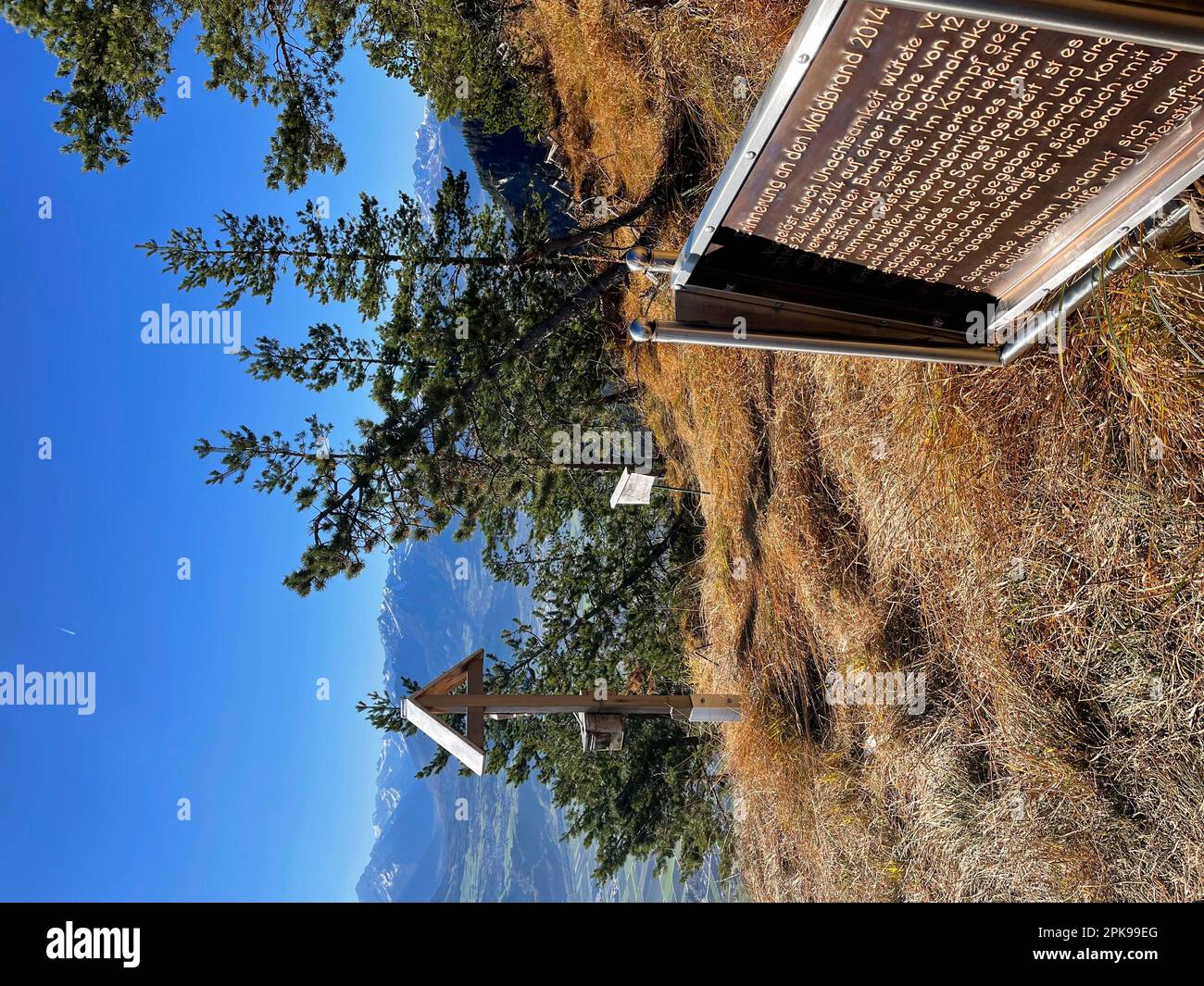 View of cross and memorial plaque below Hochmahdkopf, forest fire 2014 ...
