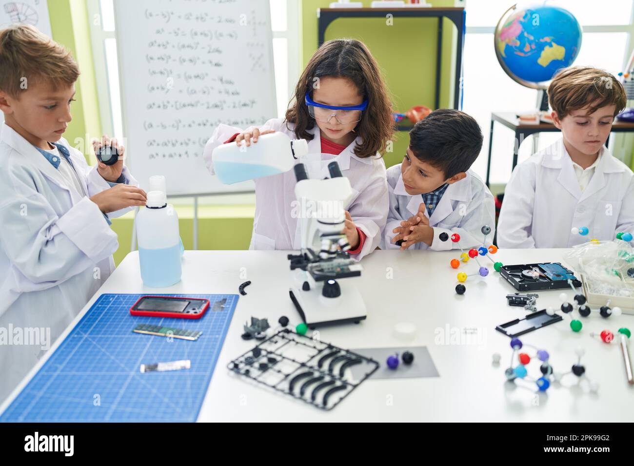 Group of kids students pouring liquid on bottl doing experiment at ...