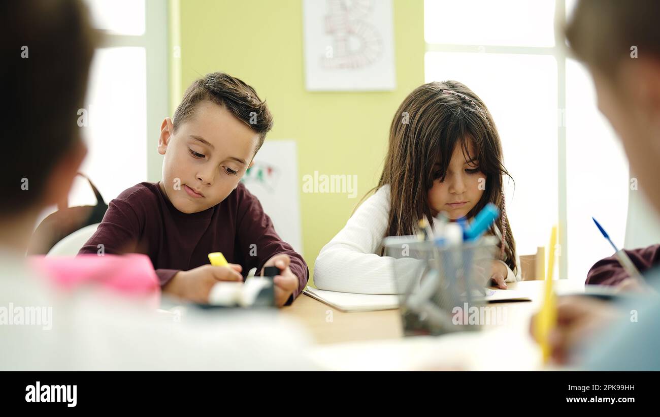 Group of kids students sitting on table studying at classroom Stock ...
