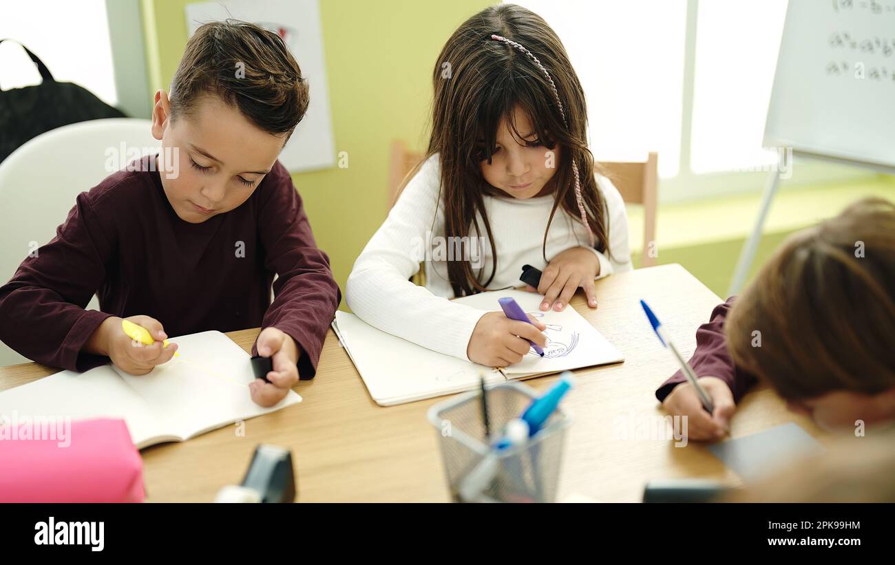Group of kids students sitting on table studying at classroom Stock ...