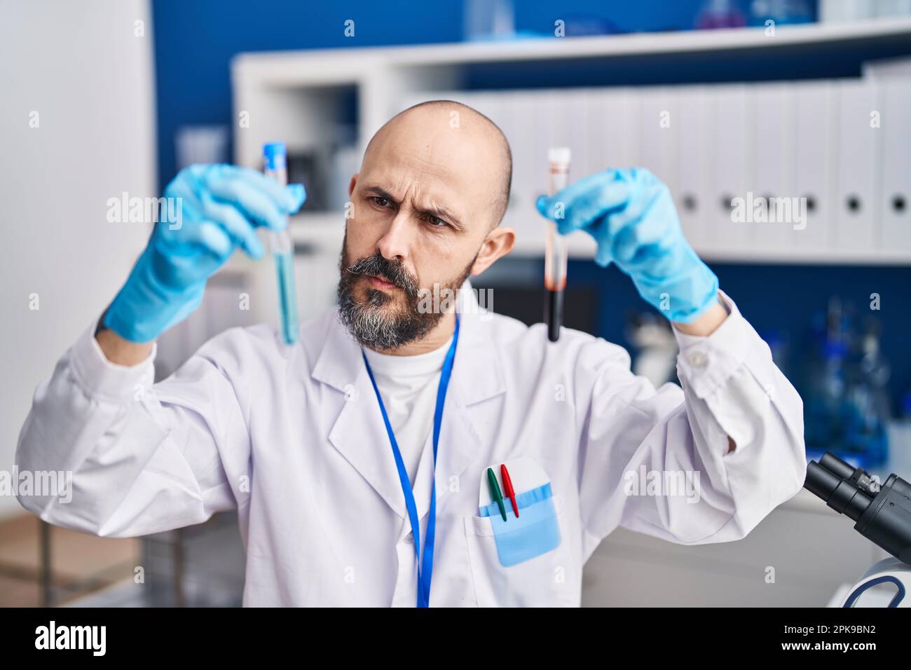 Young bald man scientist holding test tubes at laboratory Stock Photo ...