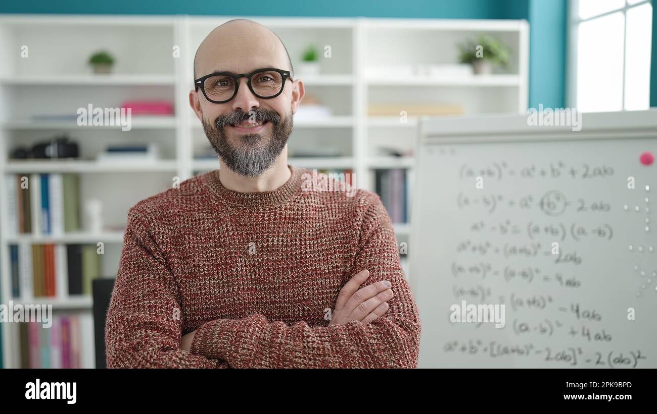 Young Bald Man Teacher Smiling Confident Standing With Arms Crossed