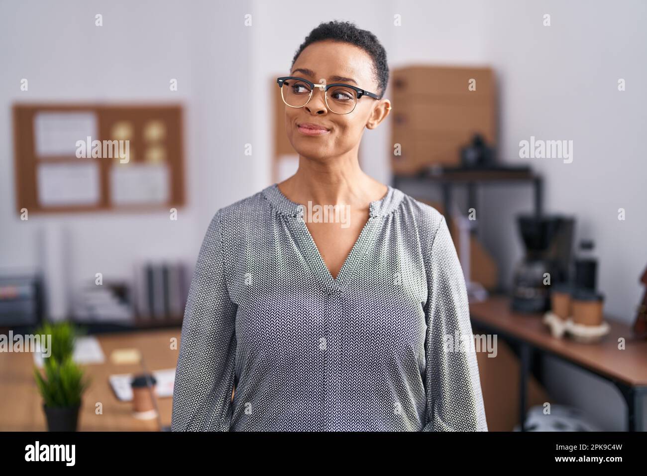 African american woman working at the office wearing glasses smiling ...