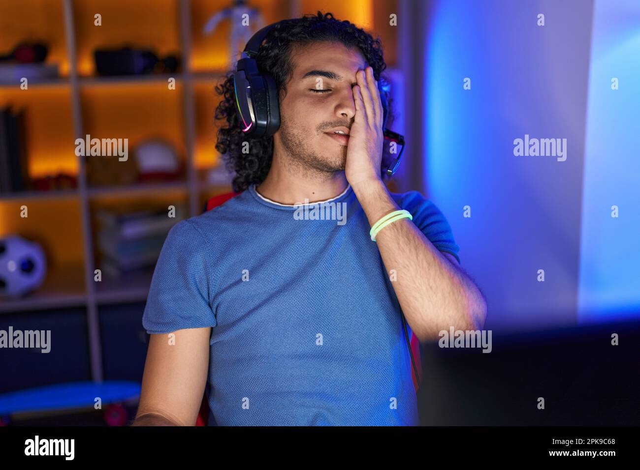 Young latin man streamer stressed using computer at gaming room Stock ...