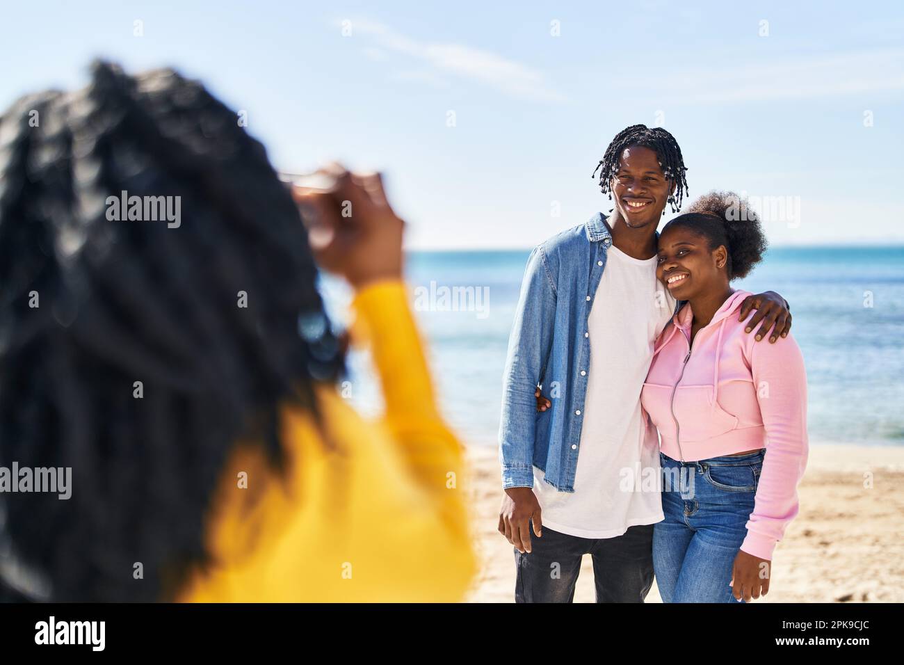 African american friends hugging each other making photo at seaside ...