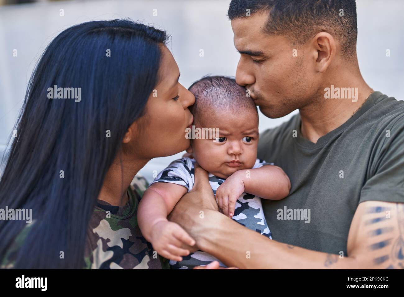 Hispanic family hugging each other and kissing at street Stock Photo ...