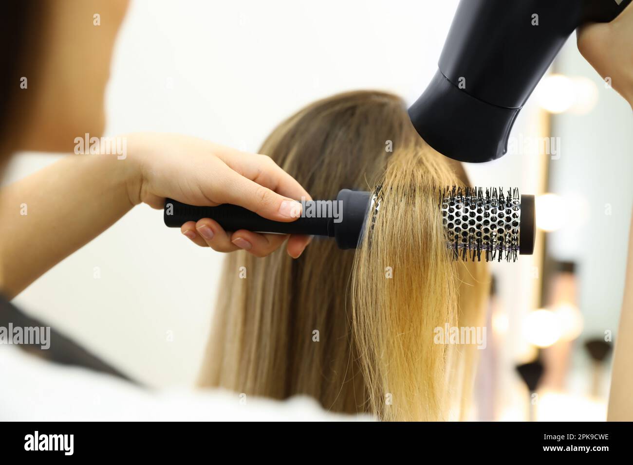 Stylist drying client's hair in beauty salon, closeup Stock Photo - Alamy