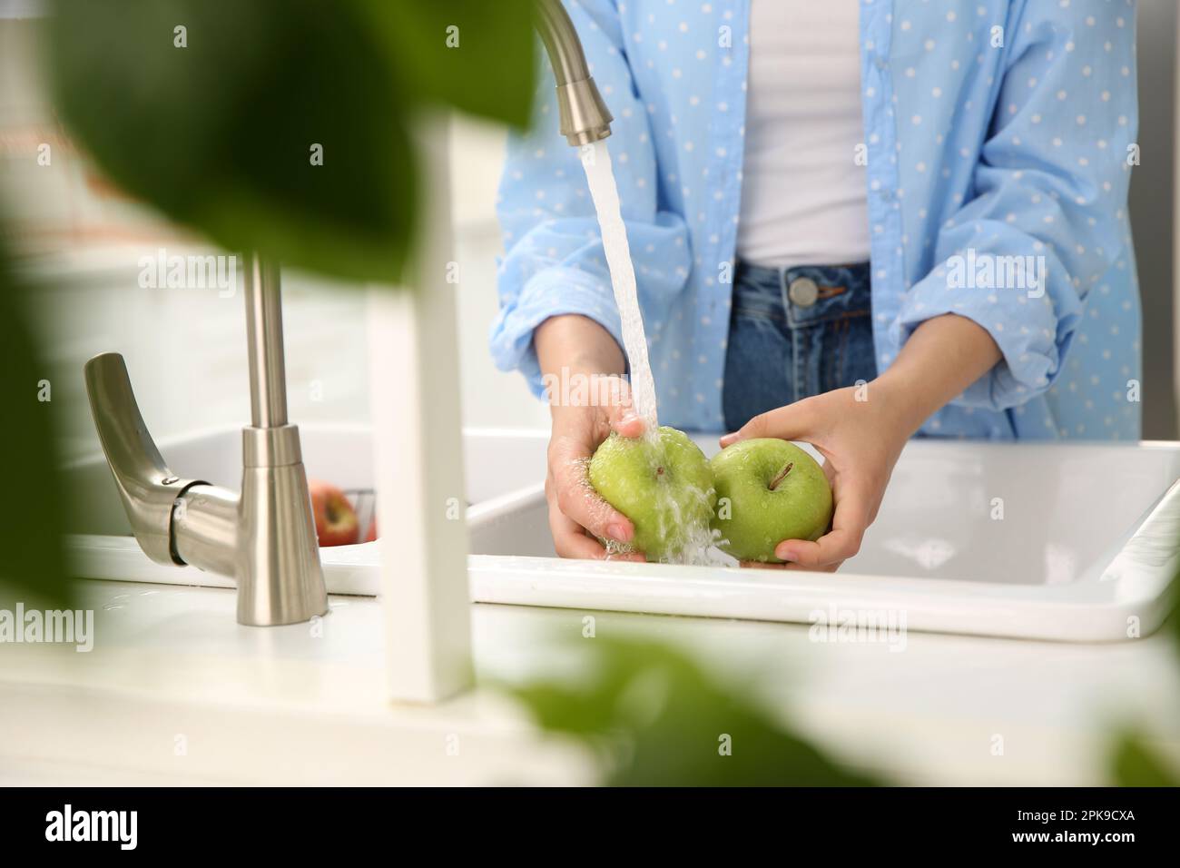 Woman washing fresh green apples in kitchen sink, closeup Stock Photo ...