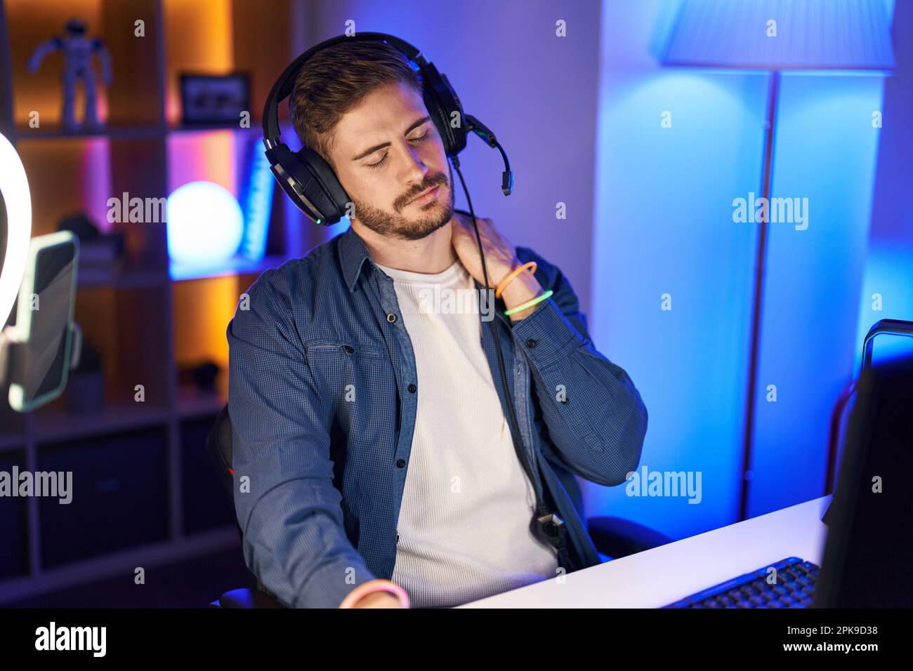 Young caucasian man streamer stressed using computer at gaming room ...