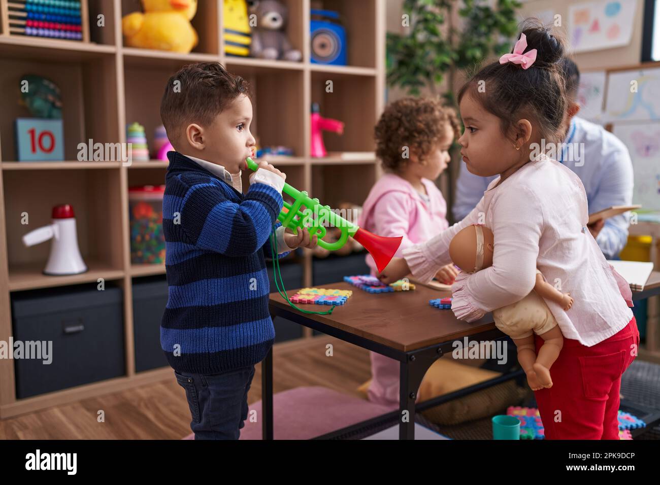 Hispanic man and group of kids having music class standing at ...