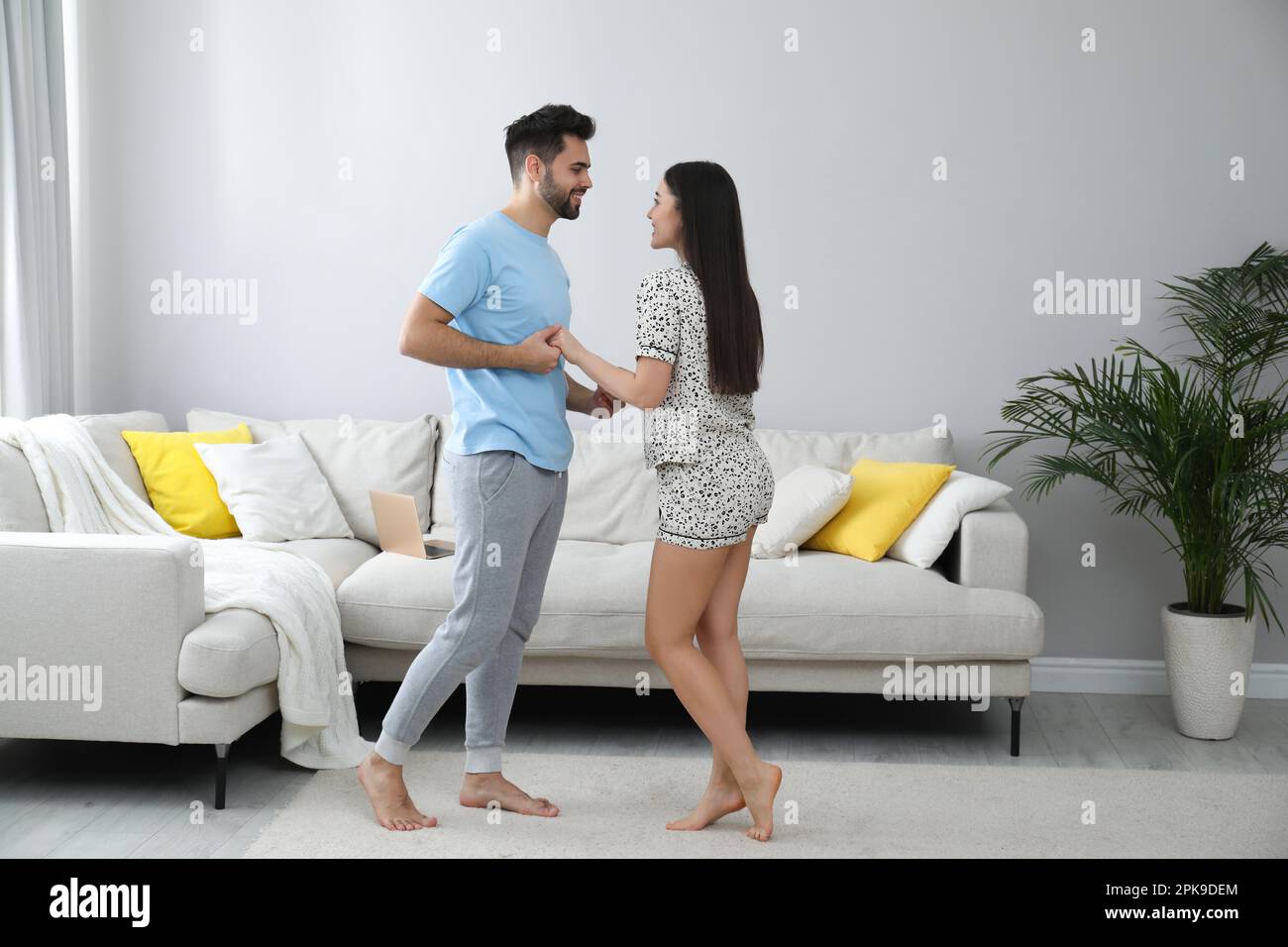 Happy couple in pajamas dancing at home Stock Photo - Alamy