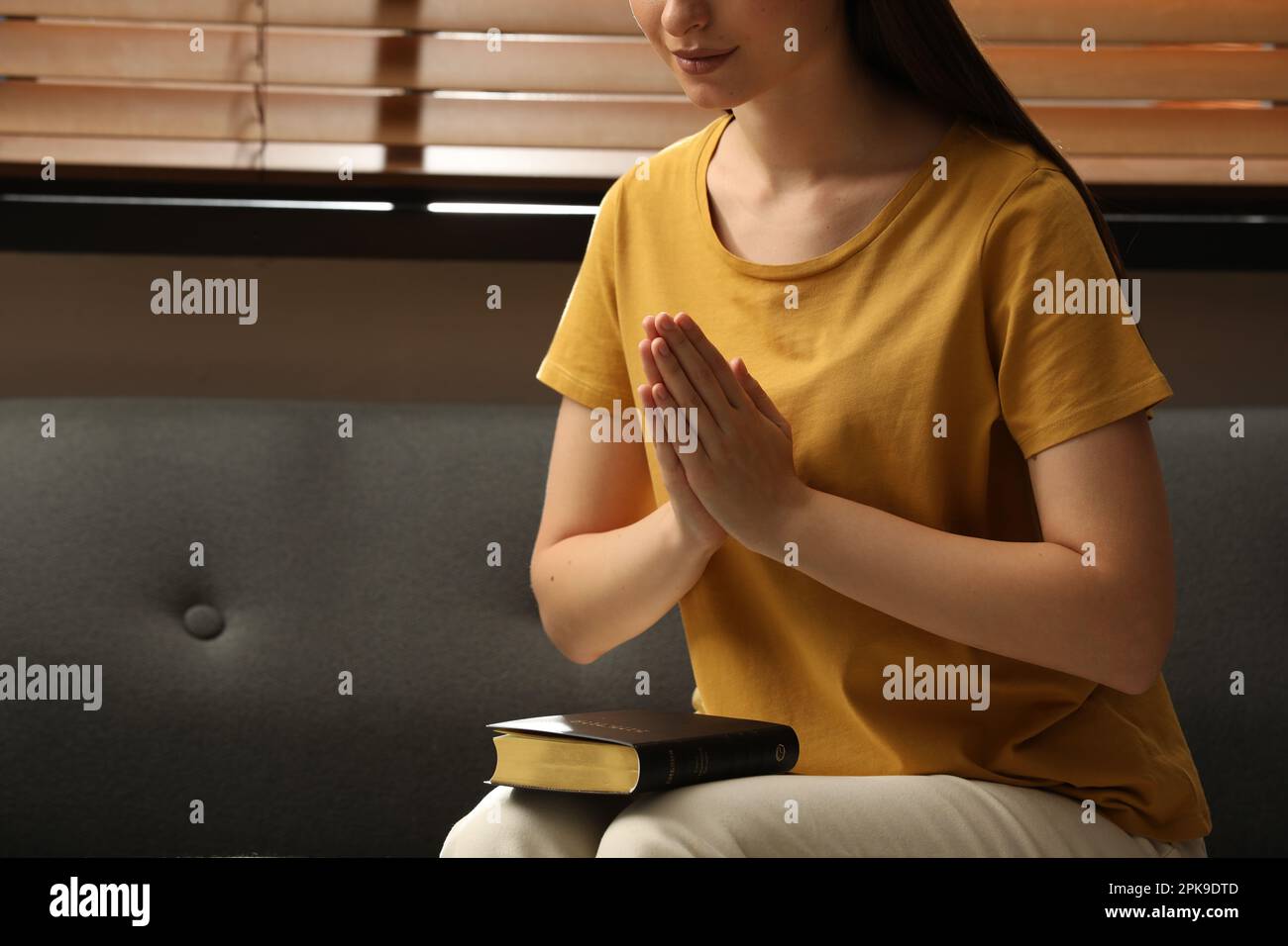 Religious woman praying over Bible indoors, closeup Stock Photo - Alamy