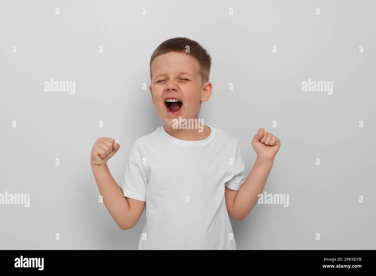 Angry little boy screaming on white background. Aggressive behavior ...