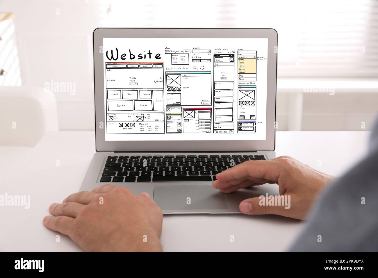 Designer creating website on laptop at white table, closeup Stock Photo ...